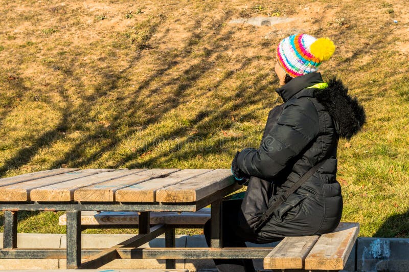 Young Woman Sitting Alone on a Bench Stock Photo - Image of bench ...