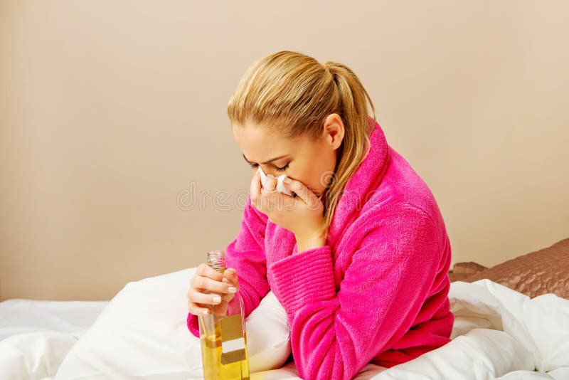 Young Woman Sitting on the Bed Crying and Drinking Whiskey Stock Photo ...