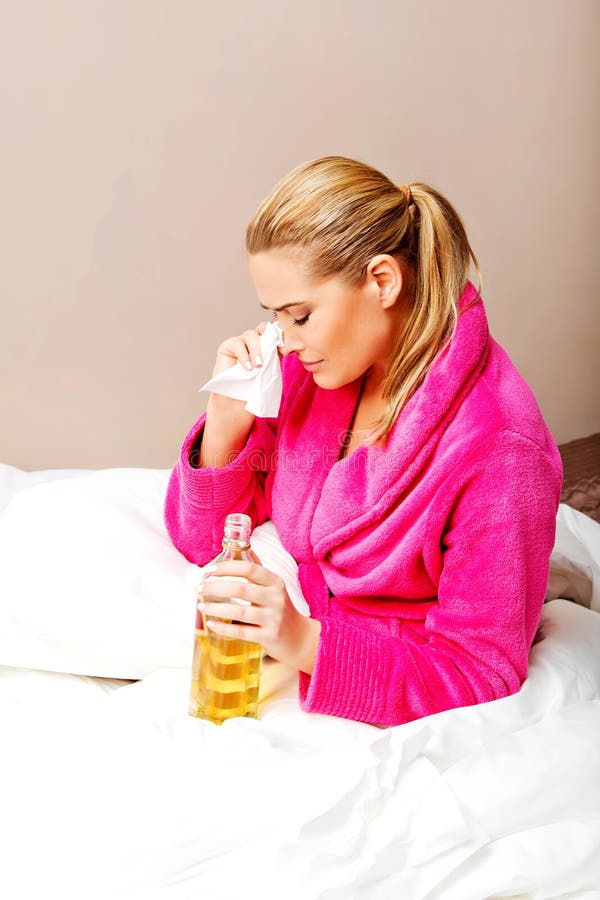 Young Woman Sitting on the Bed Crying and Drinking Whiskey Stock Image ...