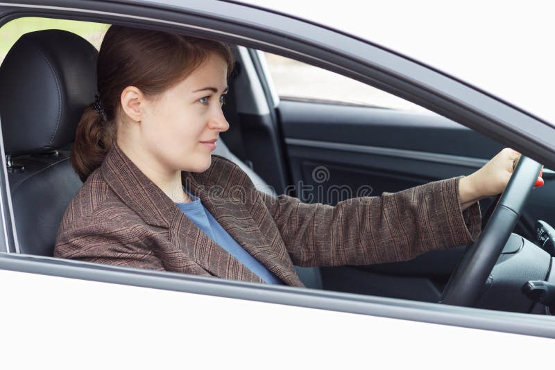 Young Woman Sitting Behind the Wheel of Car, Side View. Stock Image ...