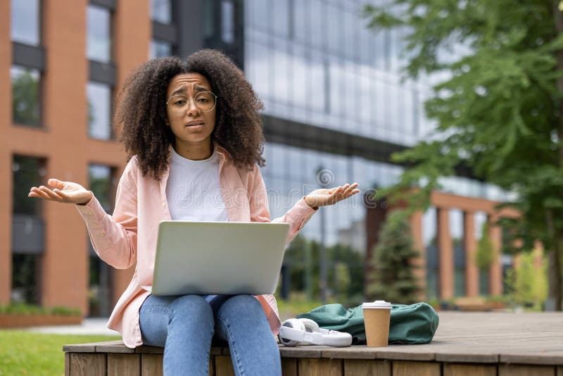 Frustrated Woman Using Laptop Outdoors at University Campus with ...