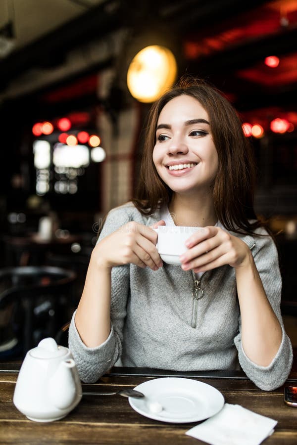 Relaxing. Attractive Cheerful Young Woman Smiling And Wearing A Shirt ...