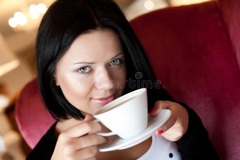 Young Woman Sitting in a Cafe Drinking Coffee Stock Image - Image of ...