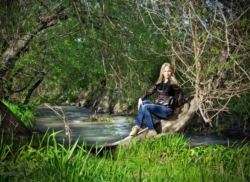 Young Woman Sitting on Dried-up Tree Stock Photo - Image of country ...