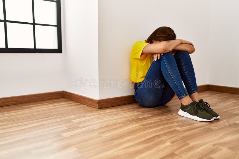 Young Woman Sitting on Floor Crying at Empty Room Stock Photo - Image ...
