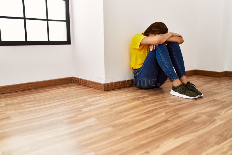 Young Woman Sitting on Floor Crying at Empty Room Stock Photo - Image ...