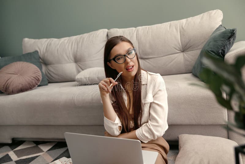 Young Woman Sitting on the Floor and Using Laptop for Remote Work ...