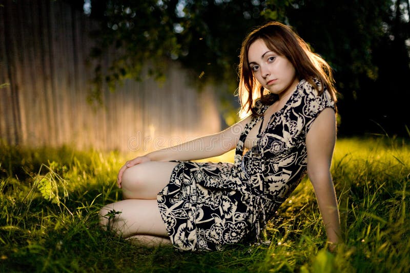 Young Woman Sitting On The Grass Stock Image - Image of dark, beautiful ...