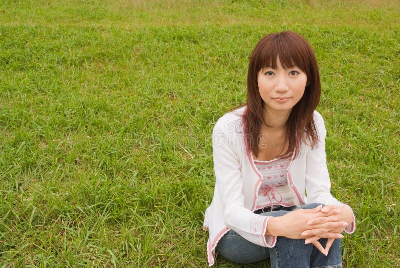 Young Woman Sitting on Grass Stock Photo - Image of twenties, female ...