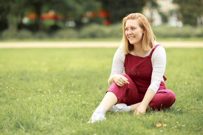 Young Woman Sitting on the Grass Stock Photo - Image of lady, carefree ...