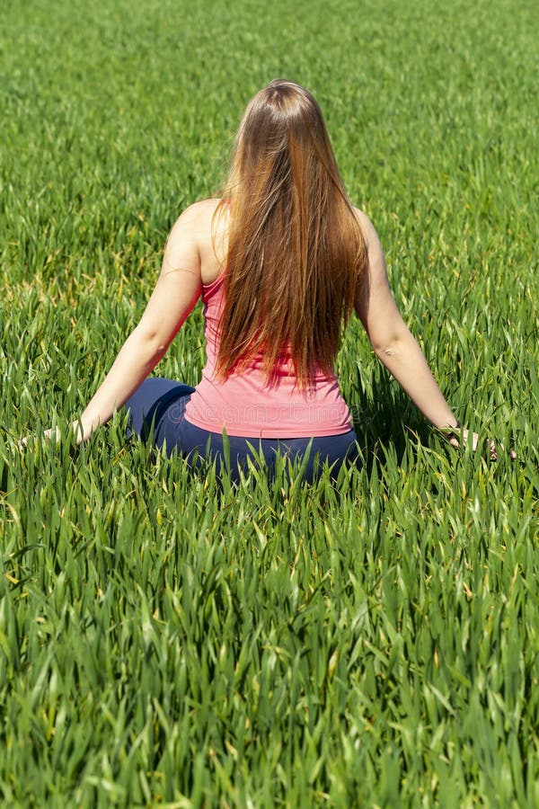 Young Woman Sitting on Green Field Stock Photo - Image of nature ...