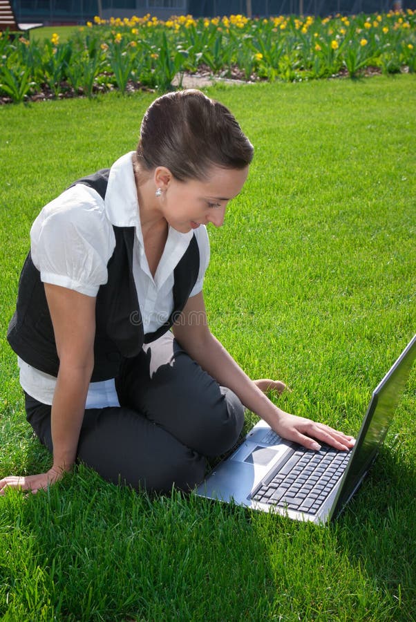 Young Woman Sitting on Lawn with Laptop Stock Image - Image of ...