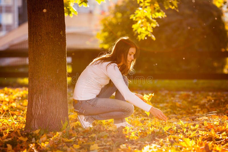 Young Woman Sitting Next To a Tree in a Park Stock Image - Image of ...