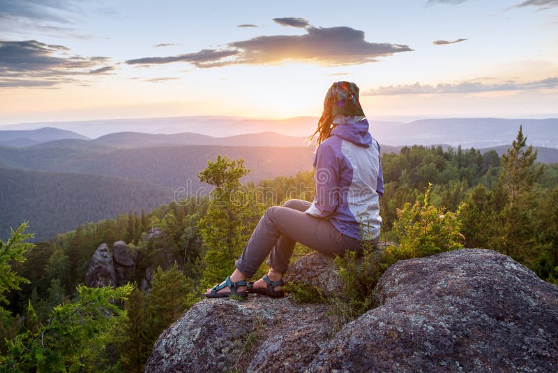 Young Woman Sitting on a Rock, Looking To the Stock Image - Image of ...