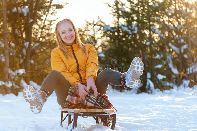 A Young Woman is Sitting on a Sled in the Winter Forest Stock Photo ...