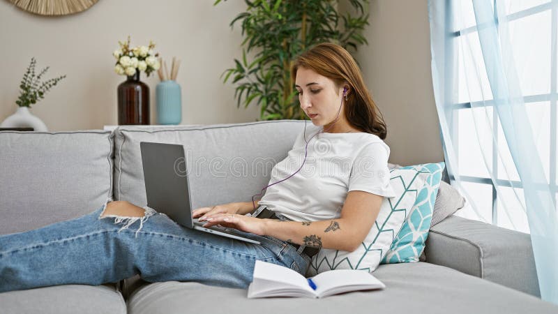 Young Woman Sitting on Sofa Studying at Home Stock Photo - Image of sofa, online: 306081696