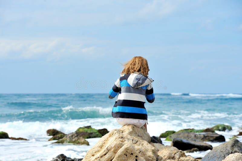 Young Woman Sitting on the Stone on the Seashore Stock Photo - Image of ...