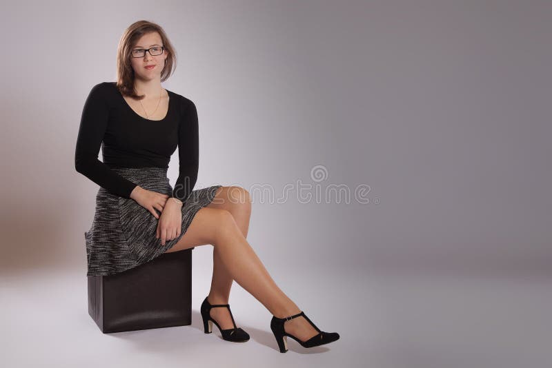 Young Woman is Sitting on a Stool Stock Photo - Image of jacket, adult ...