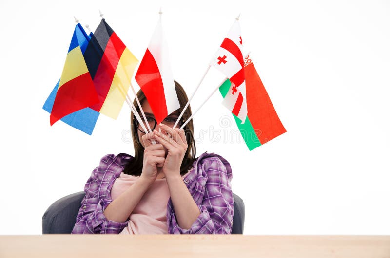 Young Woman Sitting at the Table with International Flags Stock Photo ...