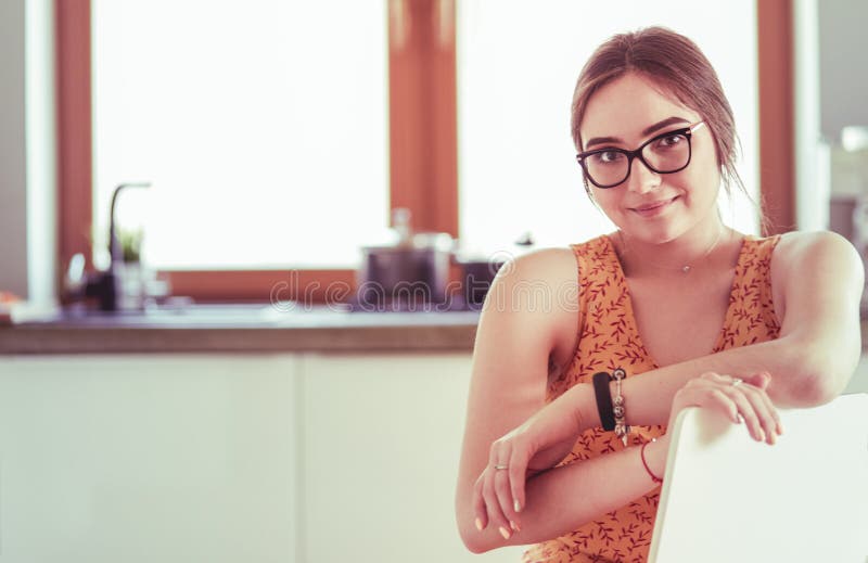 Young Woman Sitting a Table in the Kitchen Stock Photo - Image of ... Young Woman Sitting a Table in the Kitchen Stock Photo - Image of ...