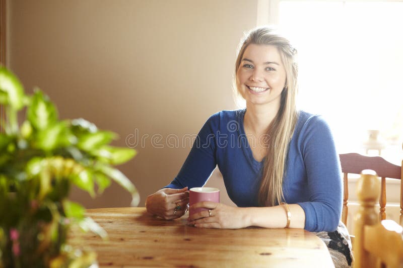 Young Woman Sitting at Table Smiling Stock Image - Image of joyfulness ...