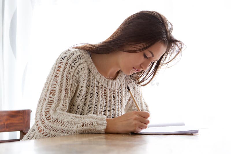 Young Woman Sitting at Table Writing in Book Stock Photo - Image of ... Young Woman Sitting at Table Writing in Book Stock Photo - Image of ...