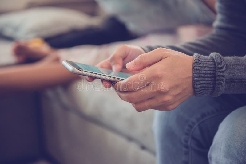 Young Woman Sitting Using Smartphone on Sofa at Home Stock Image ...