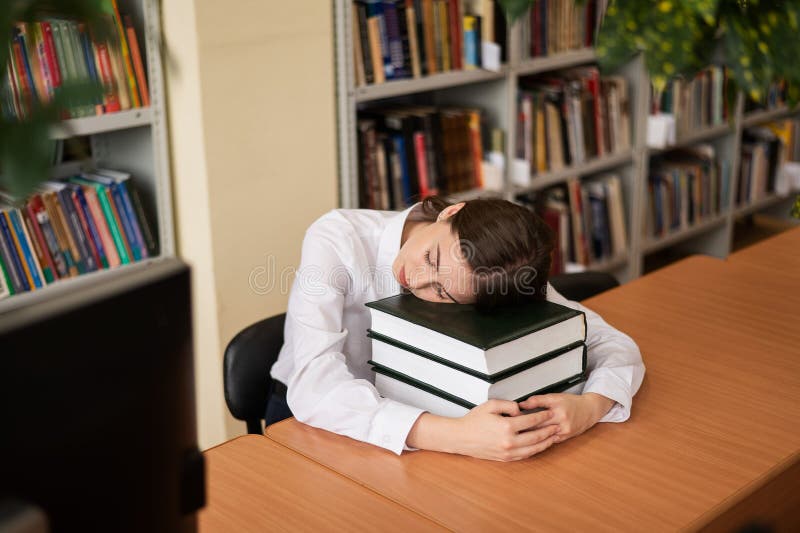Young Woman Sleeping on Textbooks in a Public Library. Stock Image ...