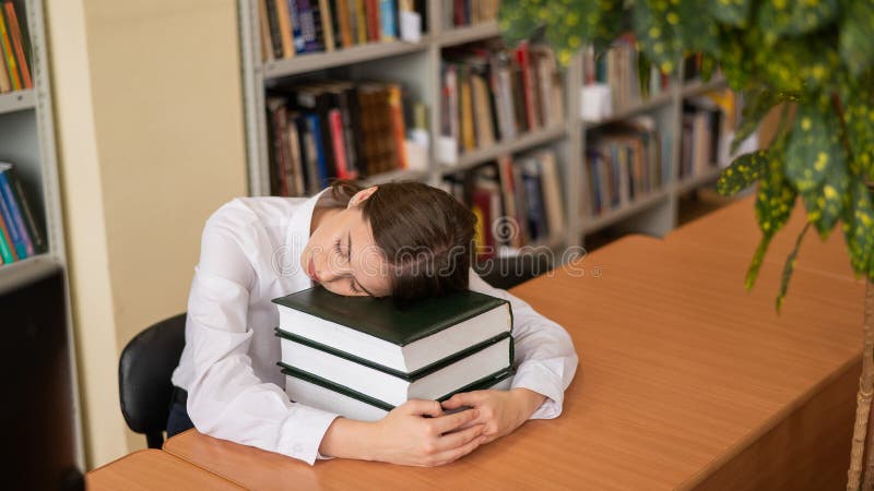 Young Woman Sleeping on Textbooks in a Public Library. Stock Image ...