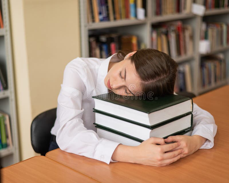 Young Woman Sleeping on Textbooks in a Public Library. Stock Image ...