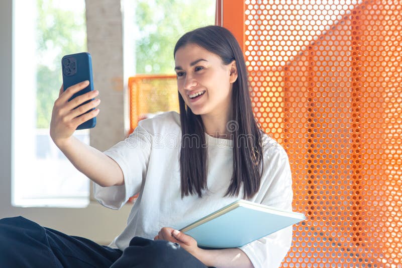 Young Woman with Smartphone and Notepad, Study Concept. Stock Photo ...