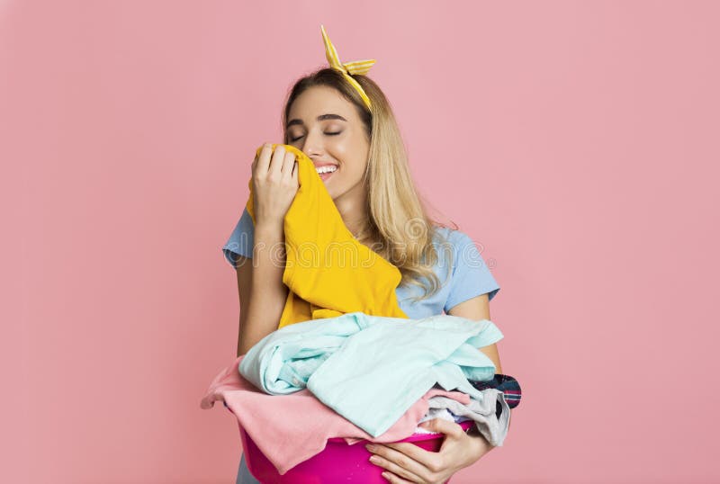 Young Woman Smelling Clean Clothes And Smiling Stock Image Image Of