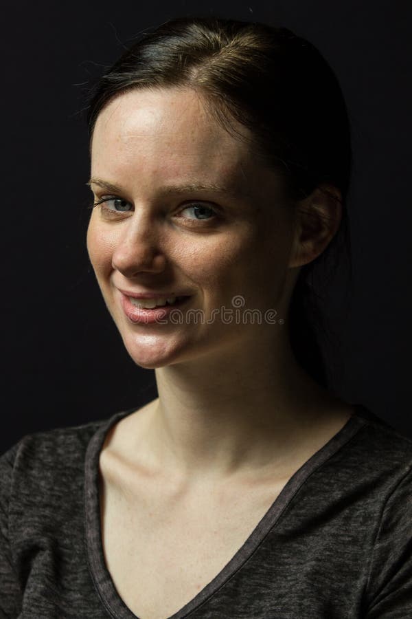 Young Woman Posing Against Black Background, Horizontal Stock Image ...