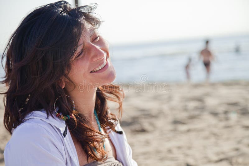 Young Woman Smiling on Beach Stock Image - Image of serenity, costume ...