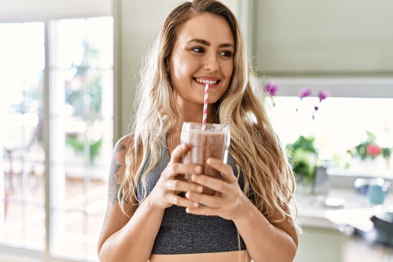 Young Woman Smiling Confident Drinking Glass of Smoothie at Kitchen ...