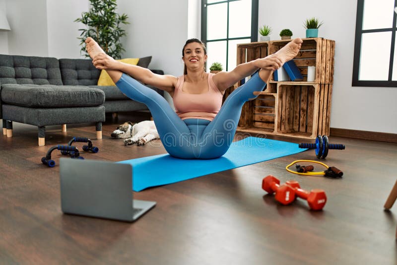 Young Woman Smiling Confident Having Online Stretching Class at Home ...