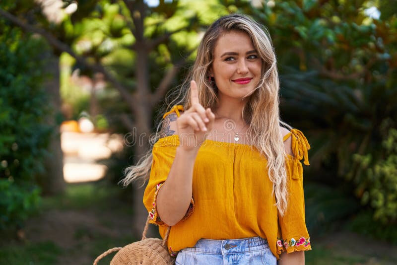 Young Woman Smiling Confident Pointing with Finger at Park Stock Image ...