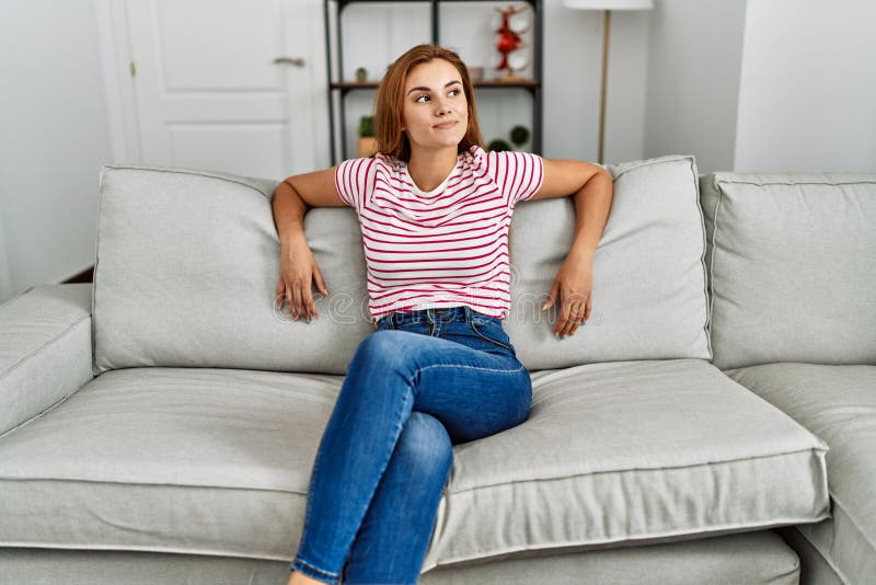 Young Woman Smiling Confident Sitting on Sofa at Home Stock Image ...