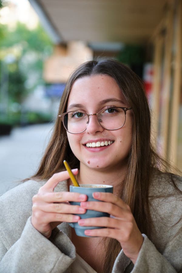 Woman Smiling and Drinking Coffee in a Cafe. Stock Photo - Image of ...