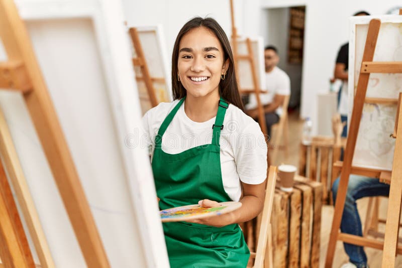 Young Woman Smiling Happy Drawing with Group of People at Art Studio ...