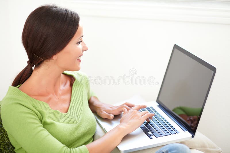 Young Woman Smiling while Using a Laptop Stock Photo - Image of ...