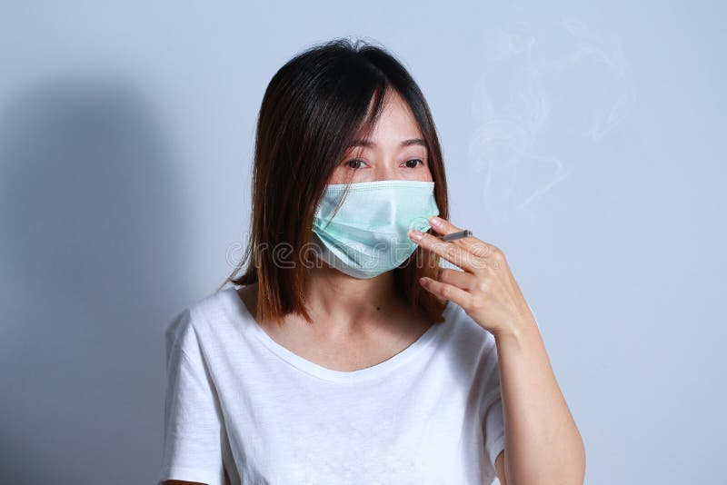 Young Woman Smoking Cigarette with Protective Mask Stock Photo - Image ...