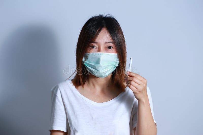 Young Woman Smoking Cigarette with Protective Mask Stock Photo - Image ...