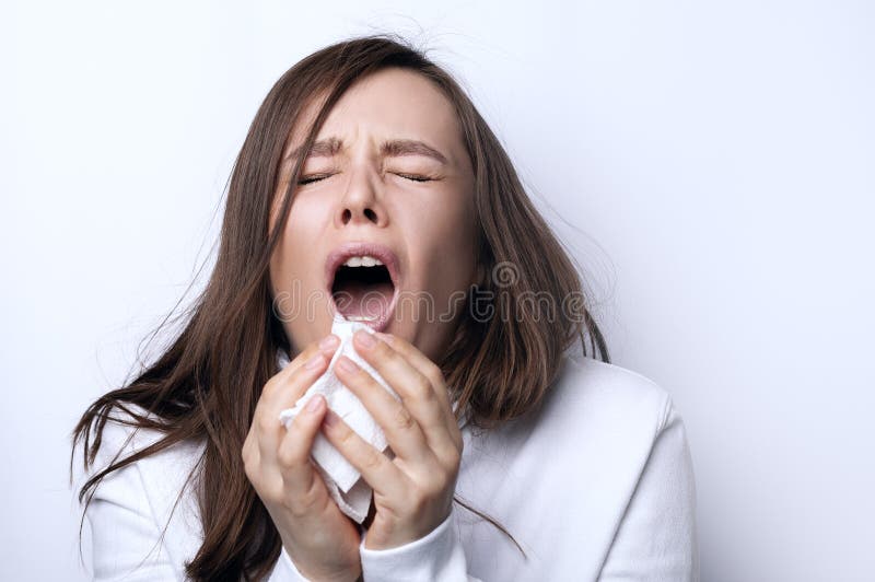 Young woman sneezing. stock image. Image of handkerchief - 176291479