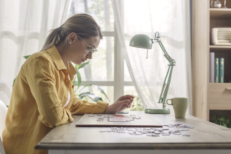 Young Woman Solving a Puzzle at Home Stock Photo - Image of composing ...