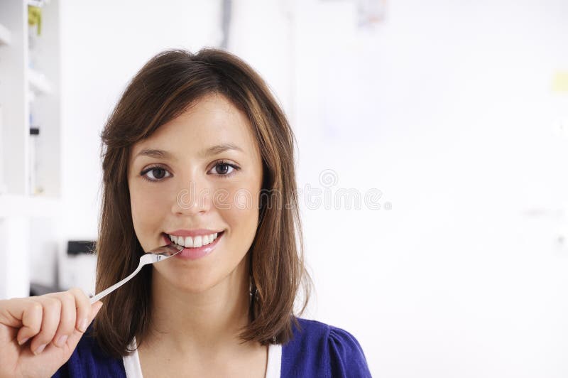 Young Woman with Spoon on Lips Stock Photo - Image of eating, nutrition ...