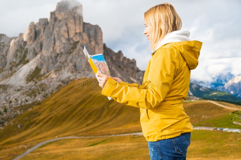 Young Woman Navigating with Map in the Dolomites Alps. Stock Photo ...