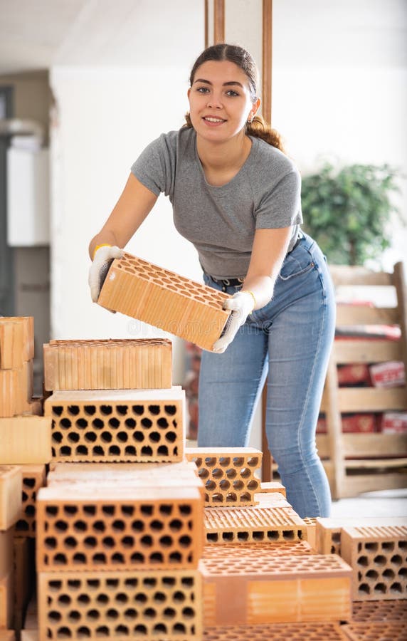 Young Woman Stacking Bricks at Construction Site Stock Photo - Image of ...