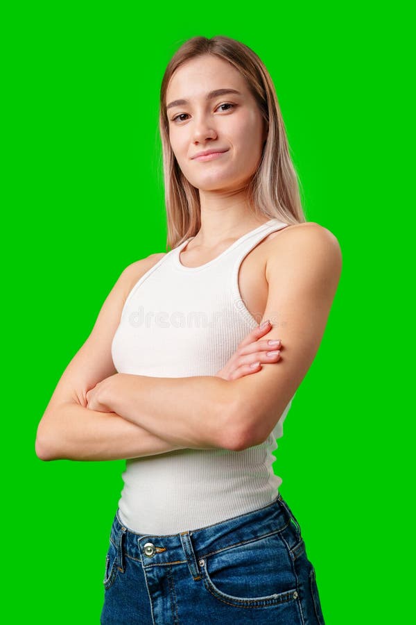 Young Woman Standing With Arms Crossed Against Green Screen Background