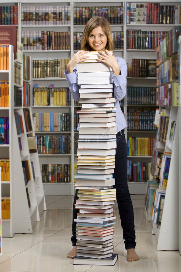 Young Woman Standing with Big Stack of Books Stock Photo - Image of ...